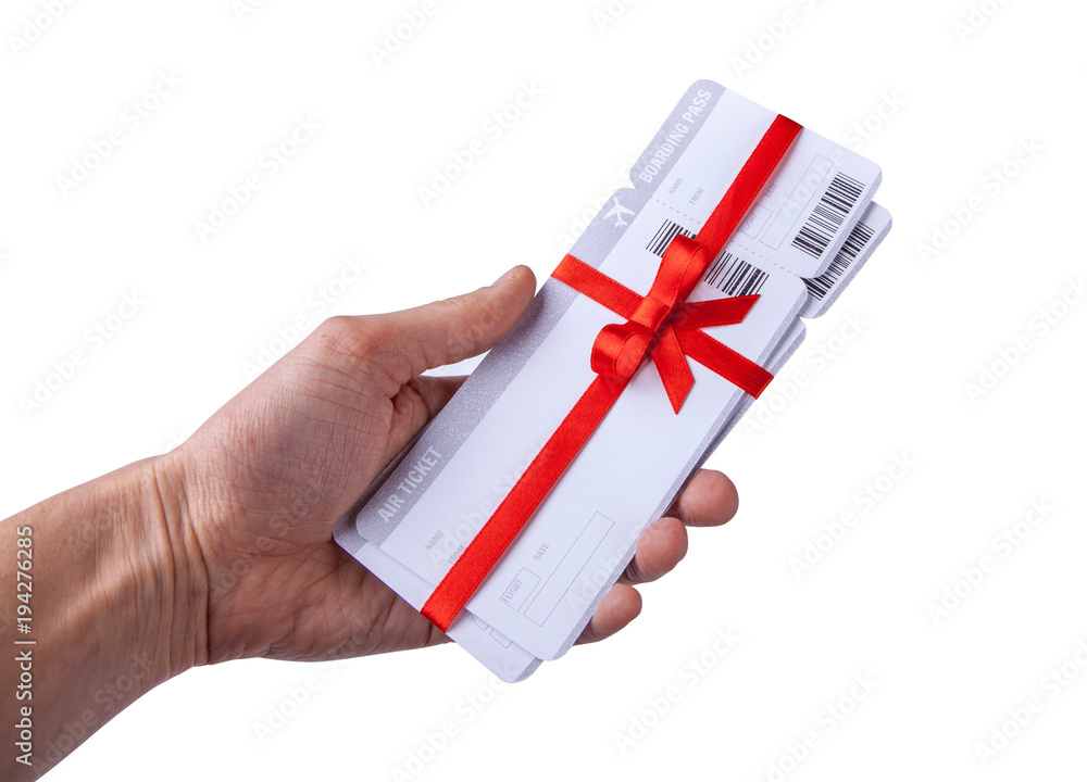 Man holds in his hand Air tickets as a gift with a red ribbon and bow ...