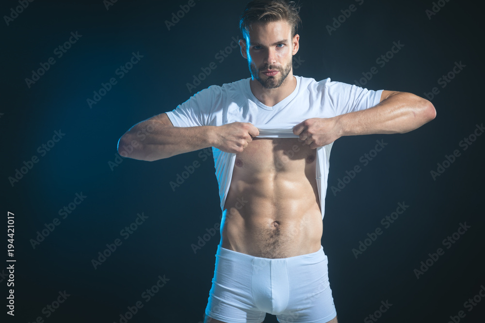 Very Sexy Young Man Showing Abdominal Muscles With Taking Off His T