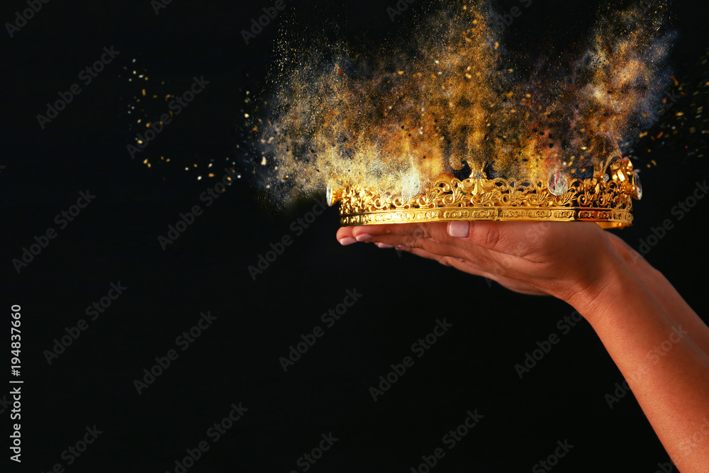 Woman's hand holding a crown for show victory or winning first place ...