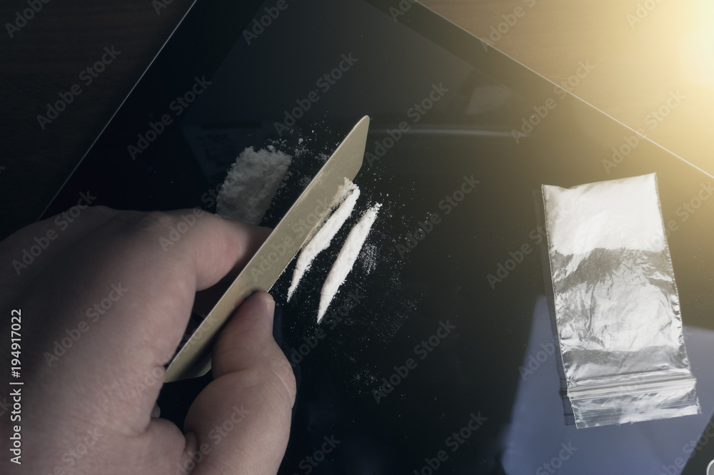 Drug Abuse. Hand of man holds credit card for making lines of cocaine ...