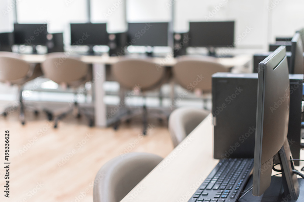 Computer lab blur background with pc desktop computer machine in blurry ...