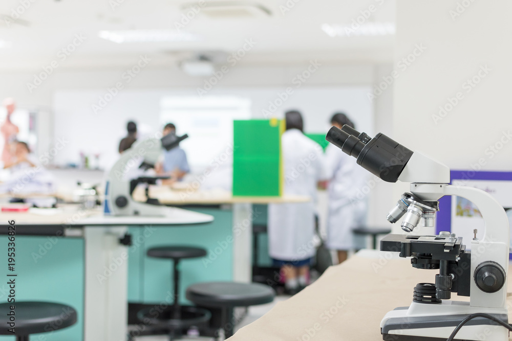 Biology or chemistry science class study with microscope and blur ...