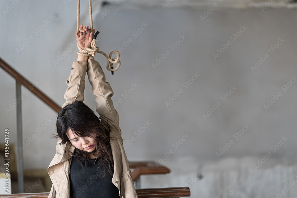 Woman kidnapped by criminals hanging with hands tied up with rope In abandoned buildings 素材庫相片 ...