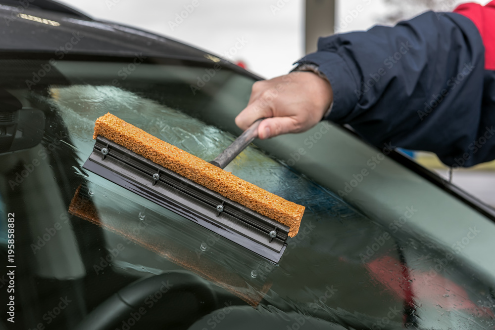 Clean a windshield with a puller for a better view. Concept ...
