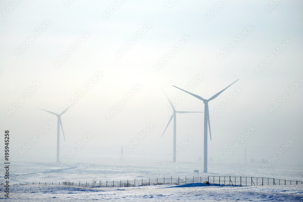 Wind power plants in winter. Wind power is the use of air flow through ...