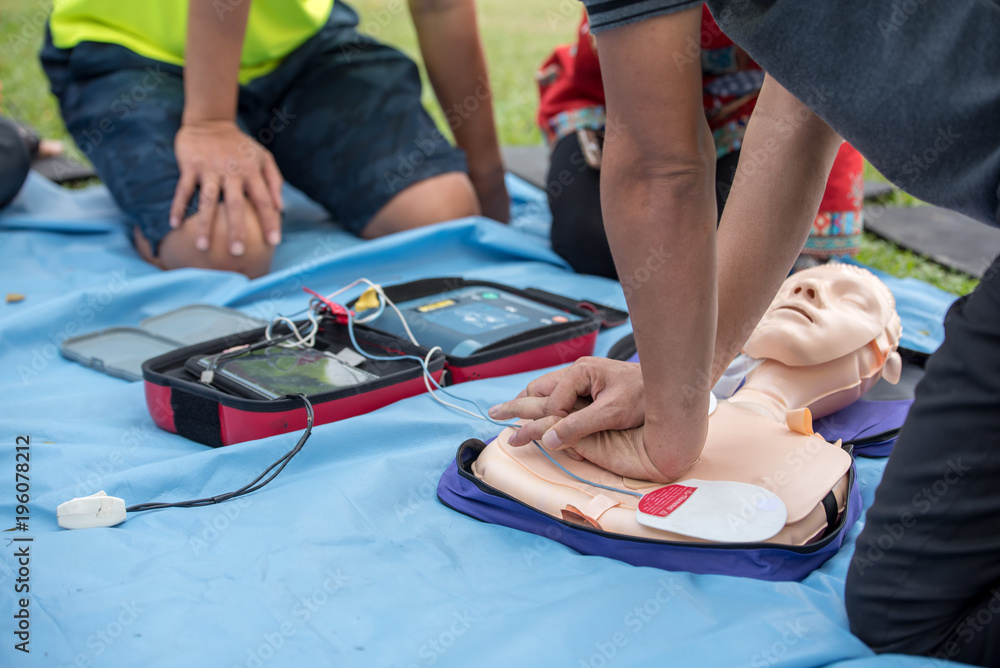 First Aid - CPR Training Chest Compression on Training Manikin with ...