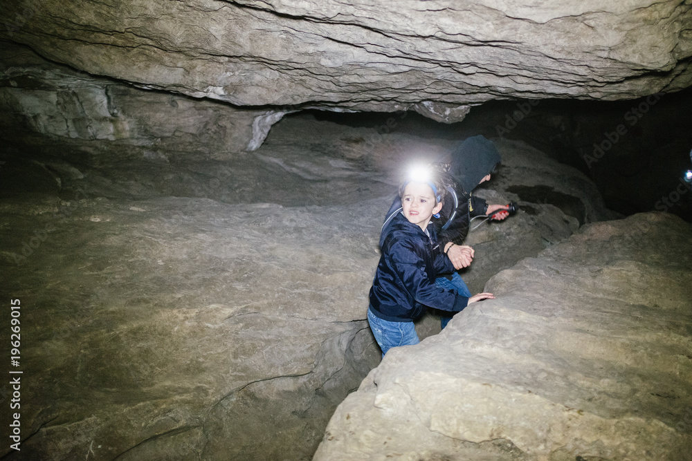 children explore underground caves, an underground karst complex of ...