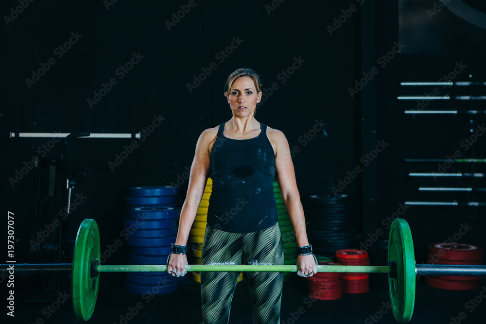 Girl athlete does dead lift exercise Stock Photo | Adobe Stock