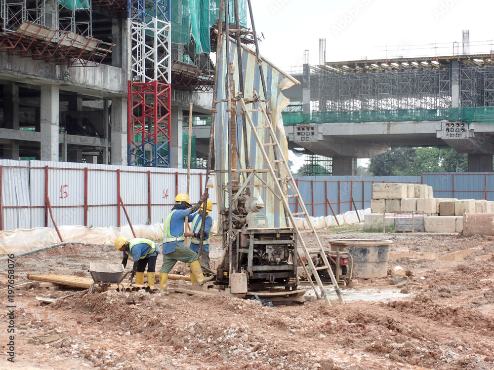 Stock-Foto „Construction workers handling the soil investigation ...