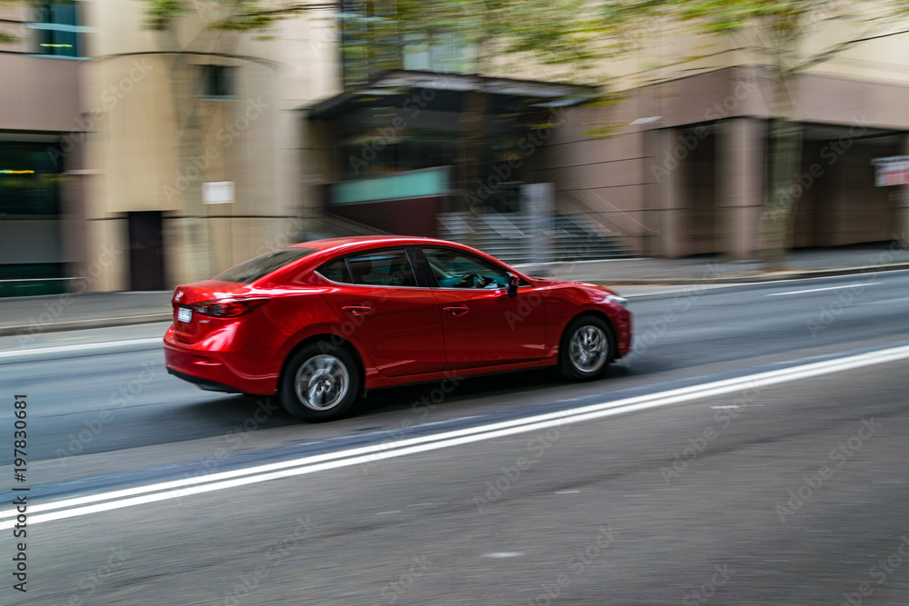 Red car in motion on the road, Sydney, Australia. Car moving on the ...