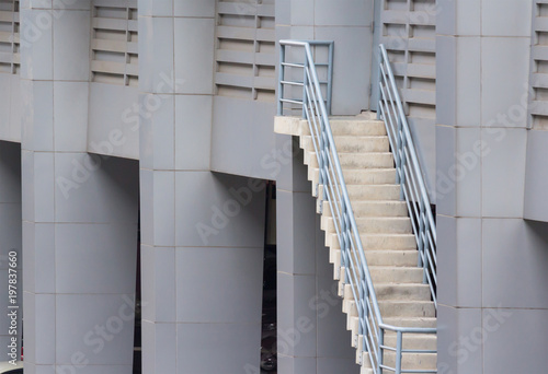 fire exit concrete stair outside the building with blue steel handrail ...
