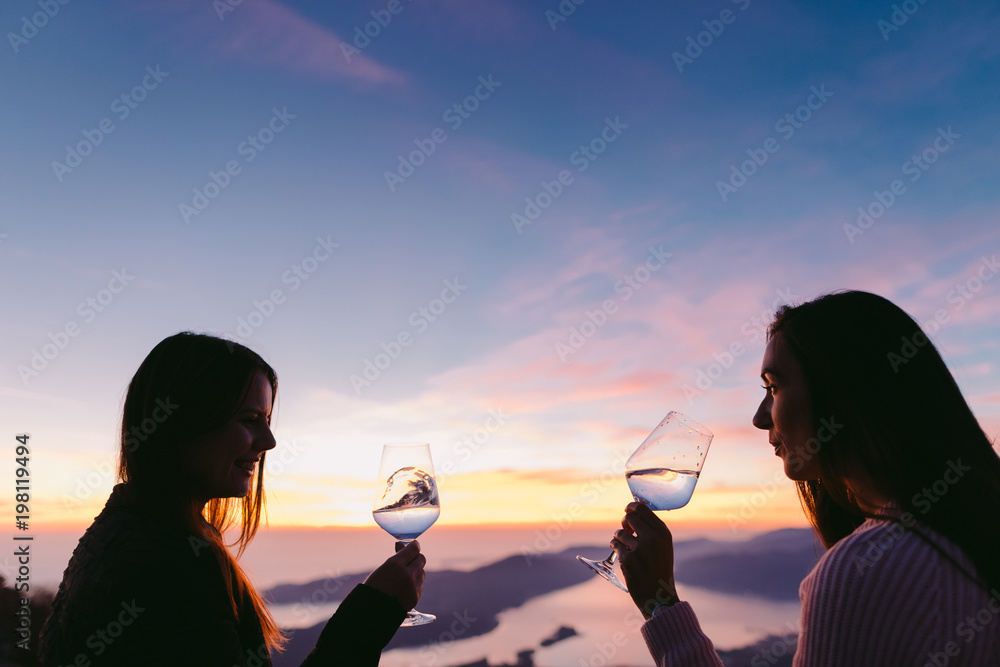 girls tasting wine at sunset Stock Photo | Adobe Stock