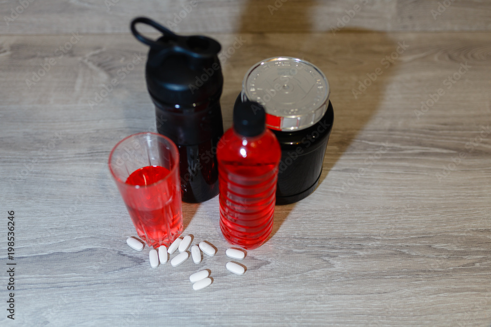 Big jar of protein powder, a Cup of energy, multivitamin tablets ...