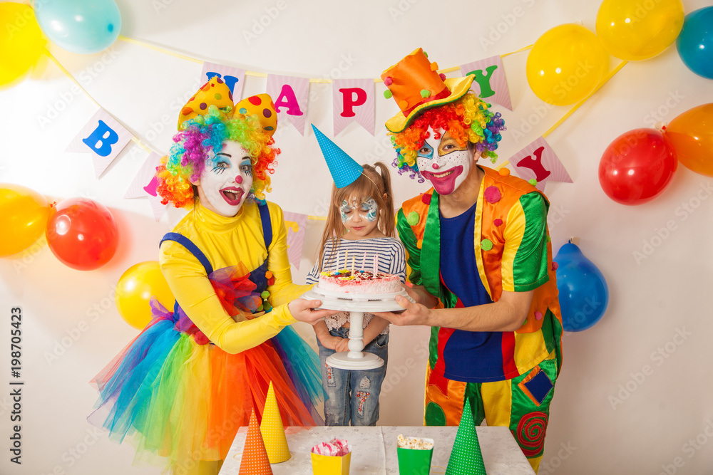 clown girl and clown boy at the birthday of a little girl. Festive ...