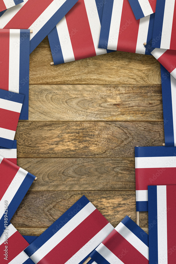 Costa Rica small flags framing a wood texture background with copy ...