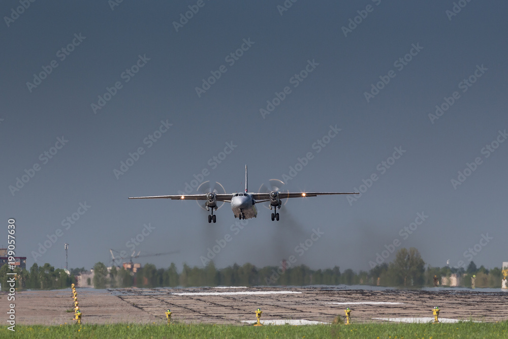 Soviet civil propeller airliner. Russian turboprop old aircraft taking off with smoke, fly low ...