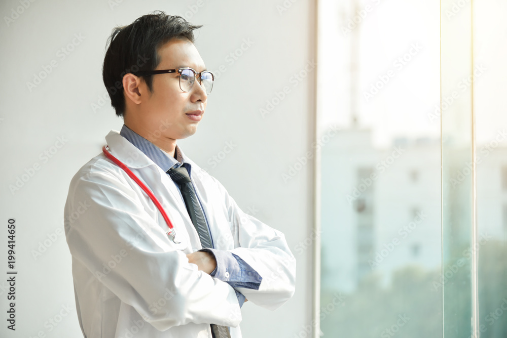 Portrait of Young Asian male Doctor is posing with arms crossed. Stock ...