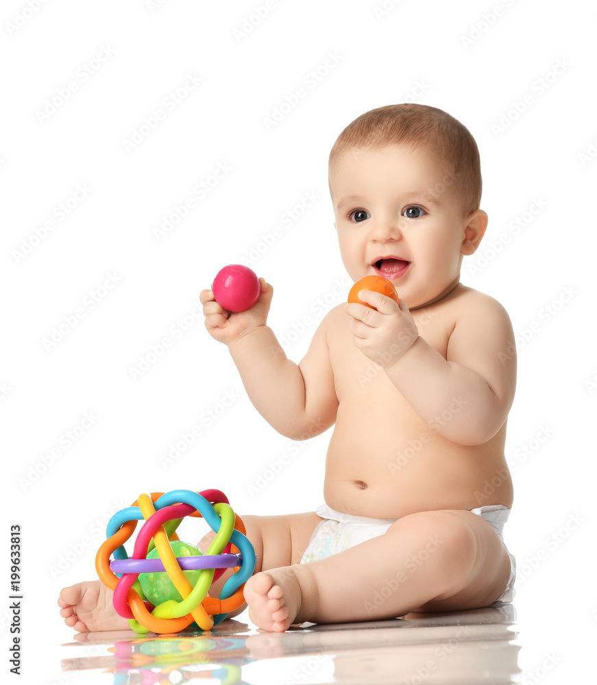 Infant child baby boy toddler sitting in diaper playing with balls and ...