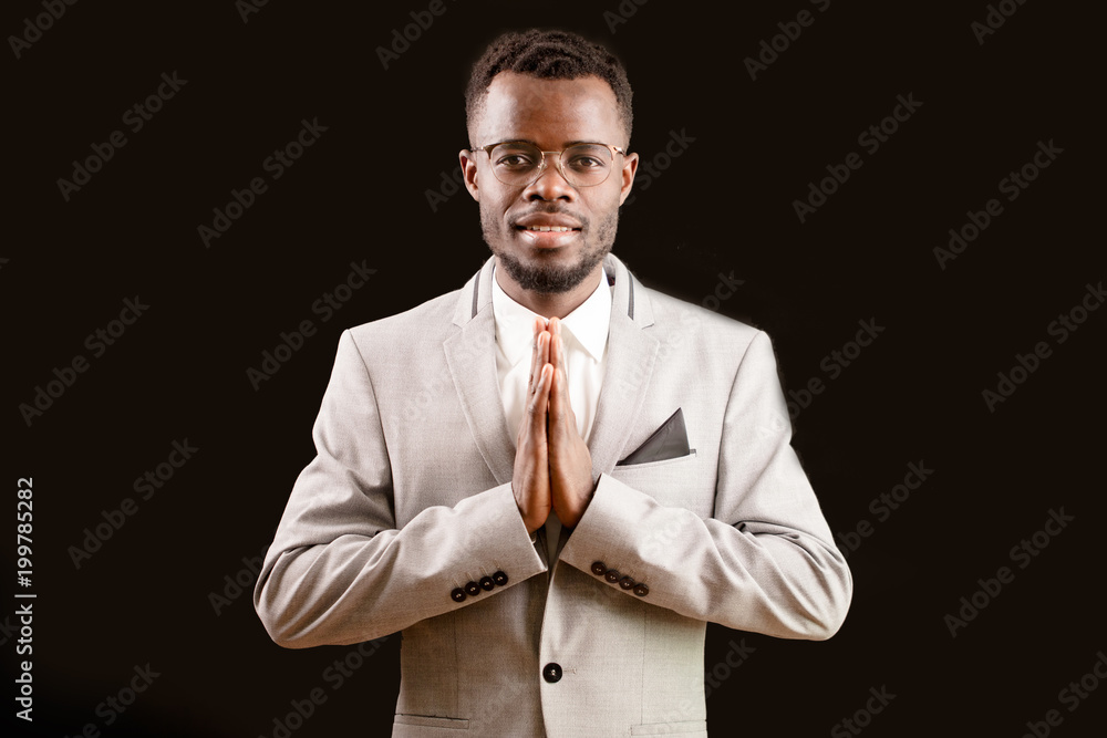 good-looking happy African male in glasses and white formal suit ...