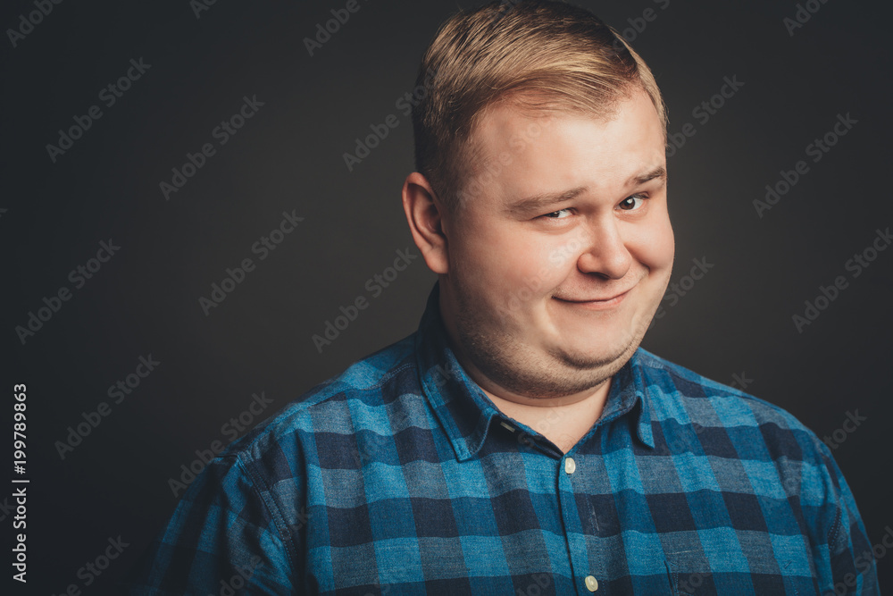 Portrait of smiling fat man on black background Stock Photo | Adobe Stock