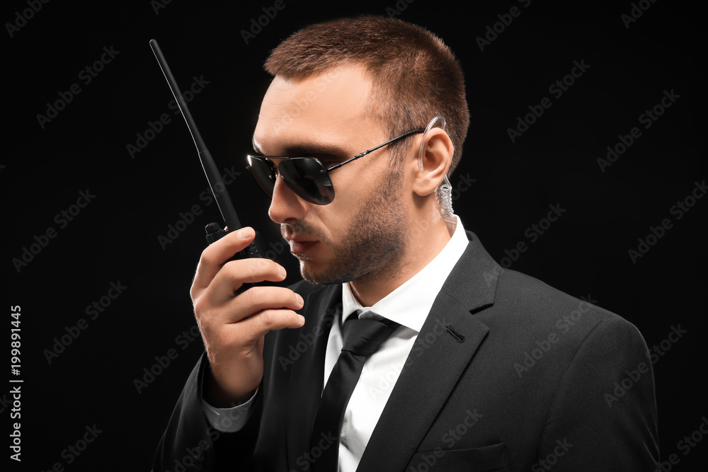 Handsome security guard on dark background Stock Photo | Adobe Stock