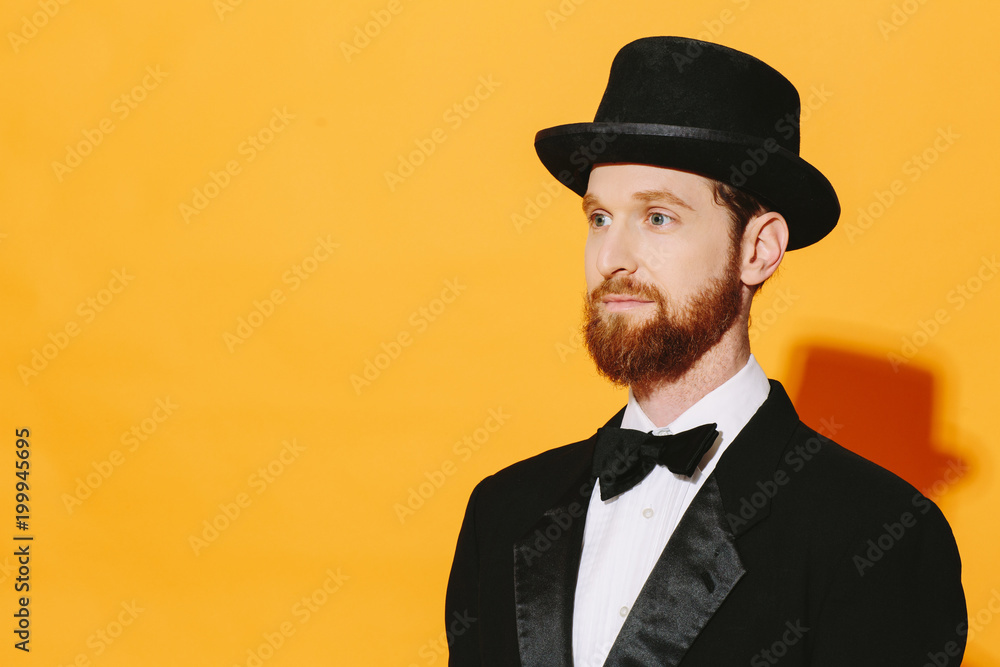 Portrait of a man with red beard in top hat and bow tie looking to side ...