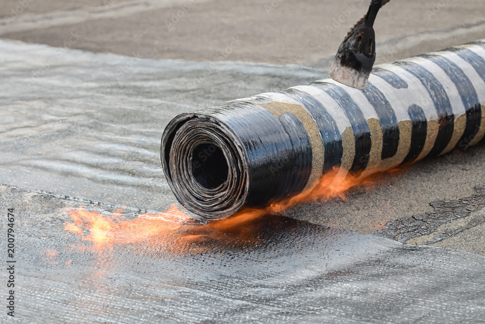Roofing installation felt with heating and melting bitumen roll by ...