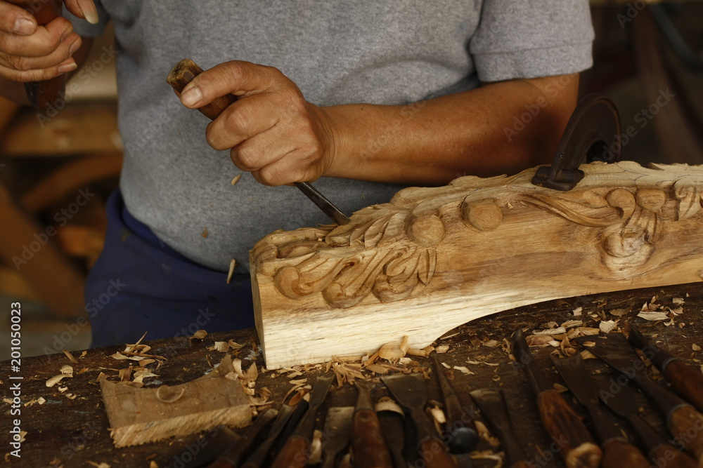 self taught skilled Thai man carving an intricate decoration on a ...
