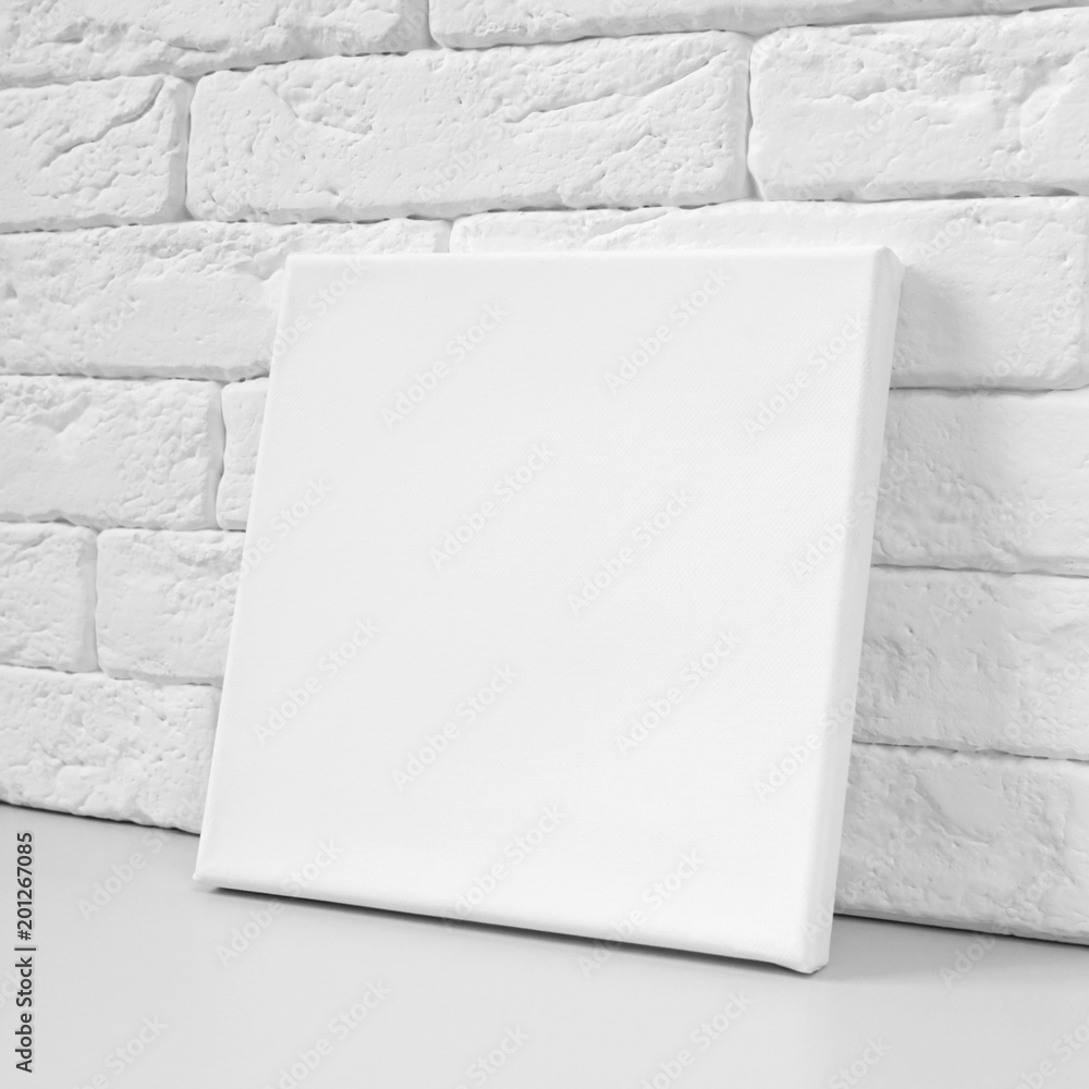 Blank square canvas against the wall. Mockup poster. Stock Photo ...