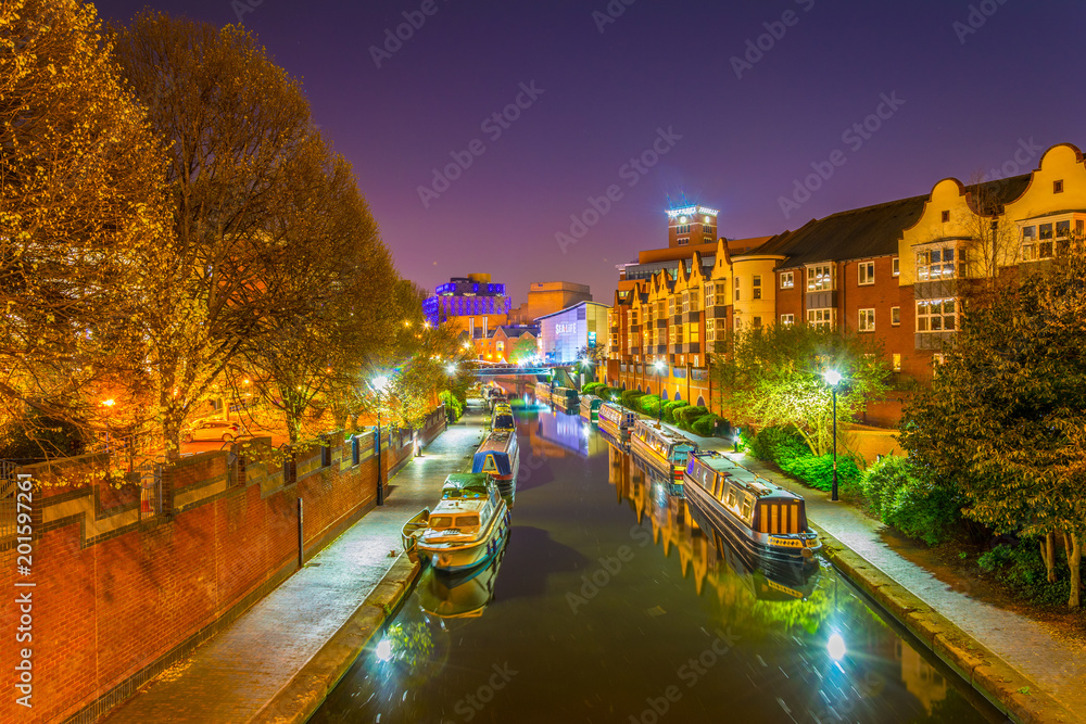 Night view of brick buildings alongside a water channel in the central ...