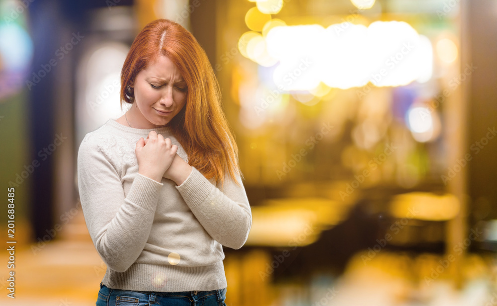 Beautiful young redhead woman crying depressed full of sadness ...