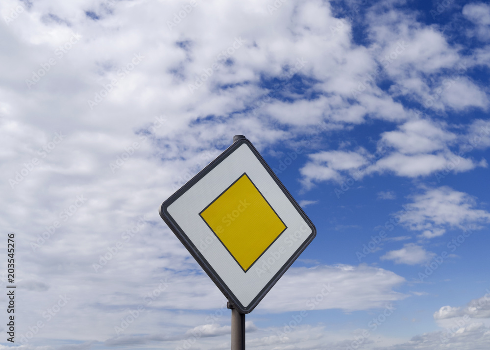 Traffic Signs / Germany: Priority road sign in front of a cloudy blue ...