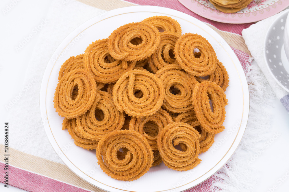 Indian Traditional Snack Chakli, a spiral shaped crisp deep fried snack ...