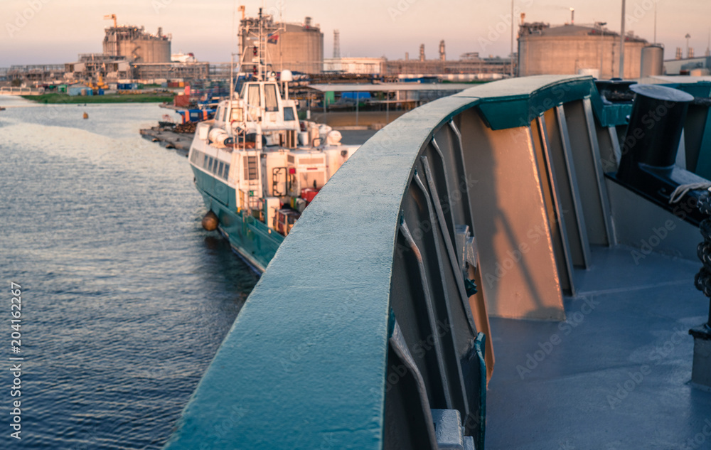 Marine vessel is morred starboard side alongside berth or quay in port ...