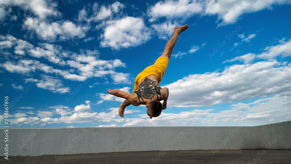 Tricking on the street. Martial arts. The guy performs the jump ...