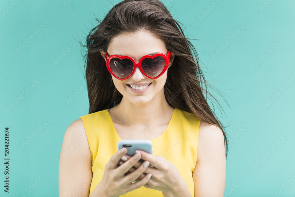 Beautiful smiling brunette girl wears yellow t-shirt and sunglasses ...