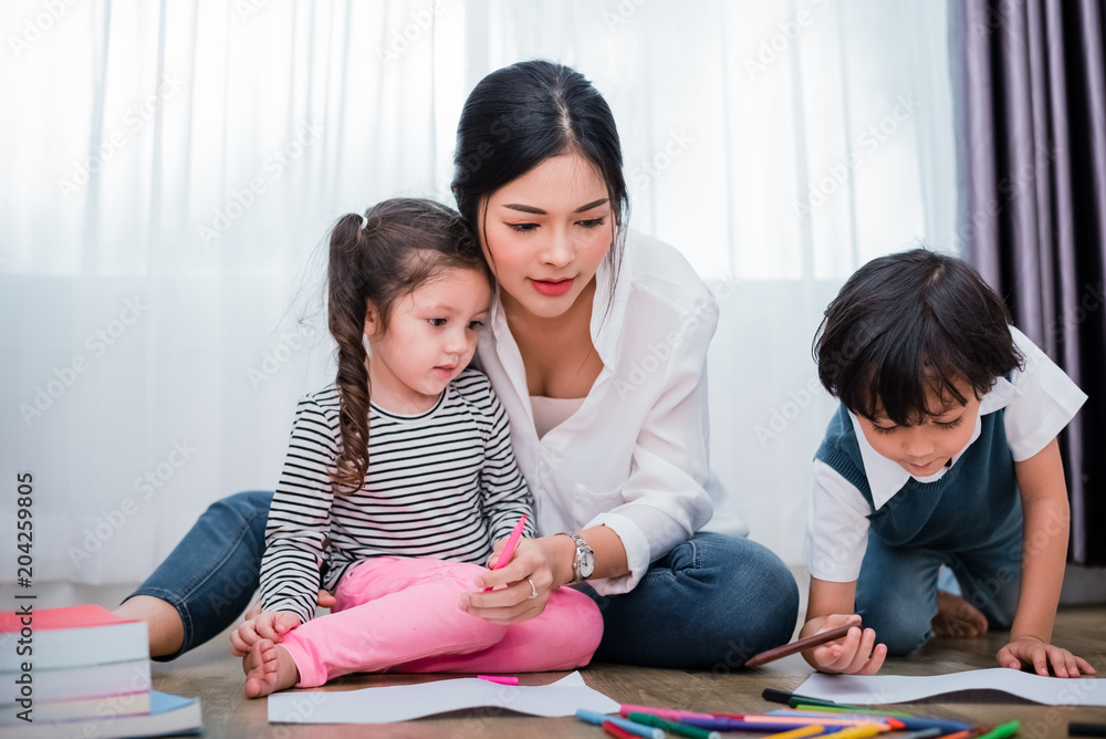Photo Stock Mother teaching children in drawing class. Daughter and son ...