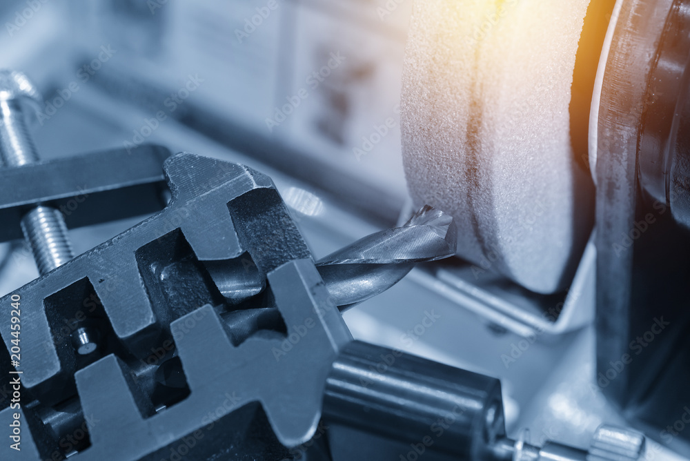 The tool sharpening machine operate in light blue scene with lighting ...