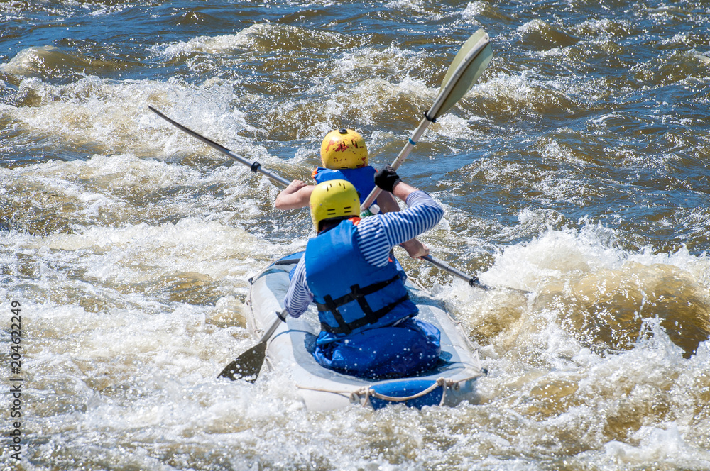 Rafting, kayaking. Two sportsmen in sports equipment are sailing on a ...