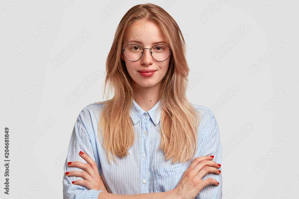Studio shot of good looking intelligent female professor, doesn`t have ...
