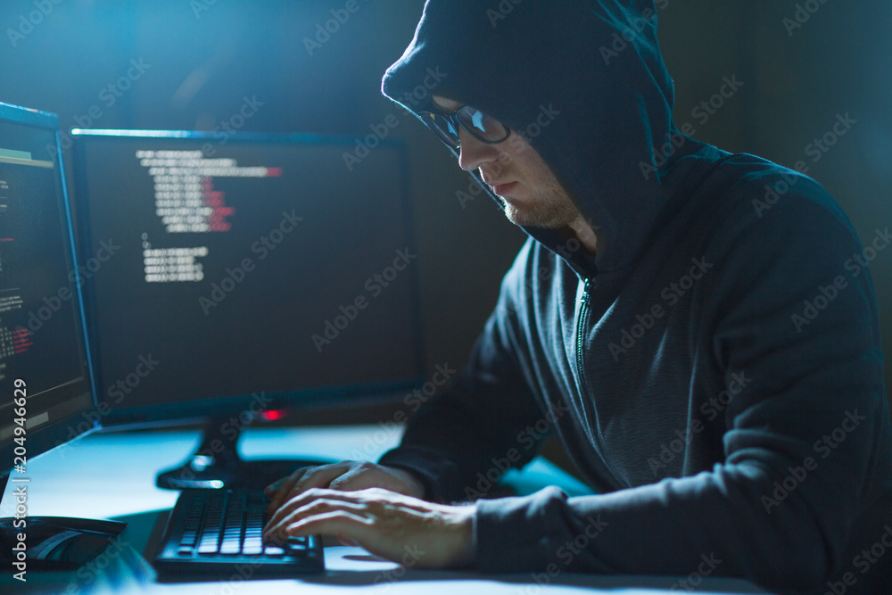 cybercrime, hacking and technology concept - male hacker in dark room ...