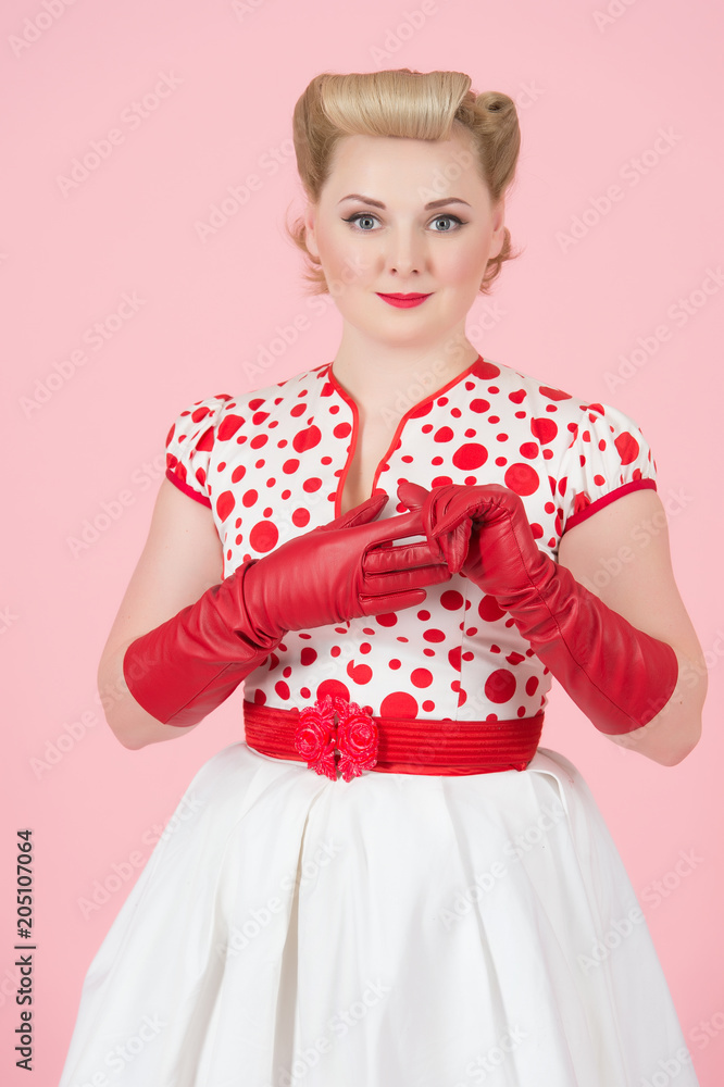 blonde pin-up styled pretty woman removes the red glove from the hand ...