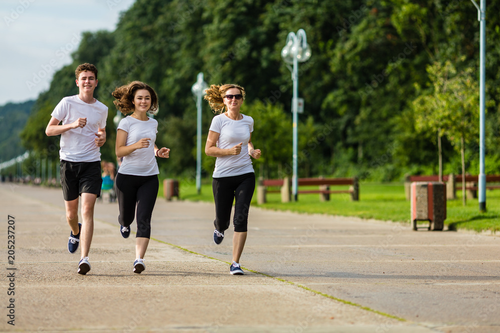 People running in city park Stock Photo | Adobe Stock