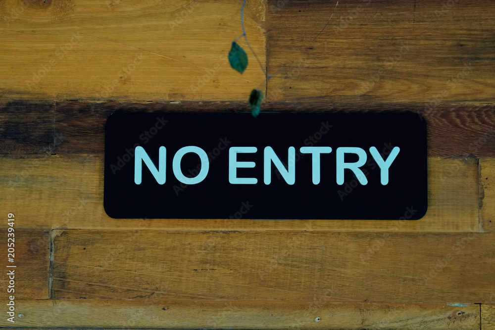 NO ENTRY sign page white word on black page with wooden on background ...