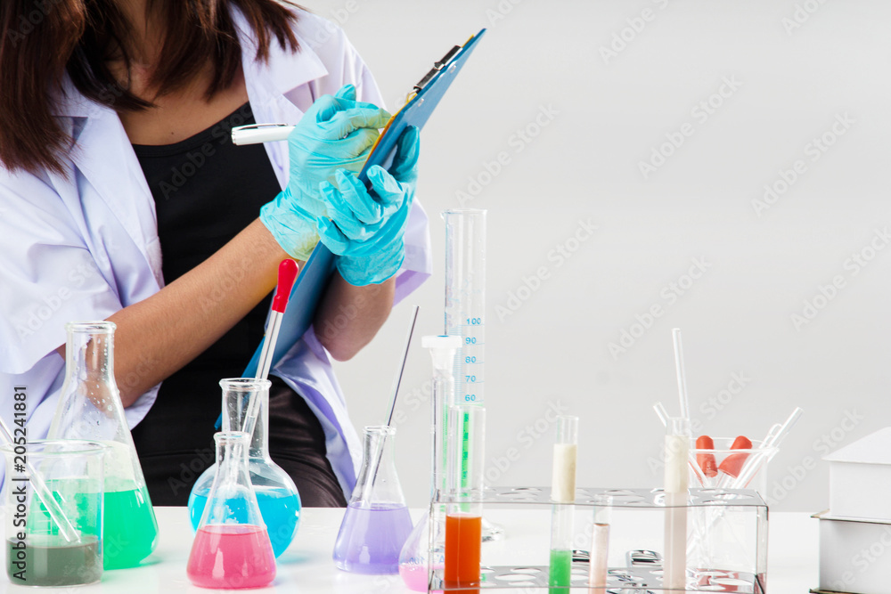 The chemist in white uniform nad wear rubber blove is working by test ...