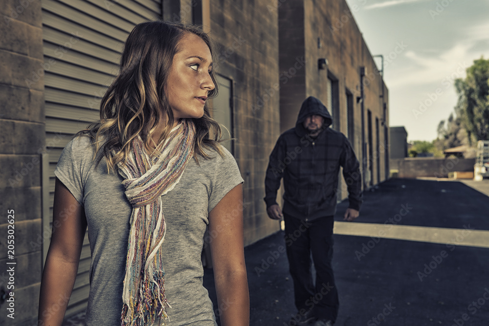 Girl who knows self defense sees a man walking behind her. Stock Photo ...