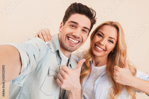 Portrait Of Two Happy People Man And Woman Taking Selfie Photo While
