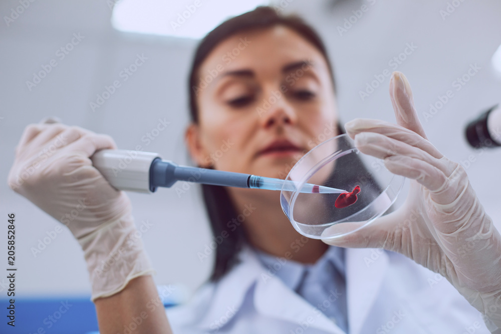 Great results. Successful smart scientist conducting a blood test and ...