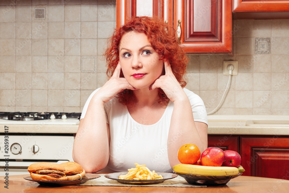 Big woman eat fast food. Red hair fat girl with burger, potato and ...