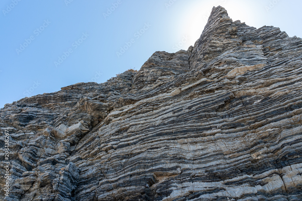Compressed rock layers formation in various colors and thicknesses, on ...
